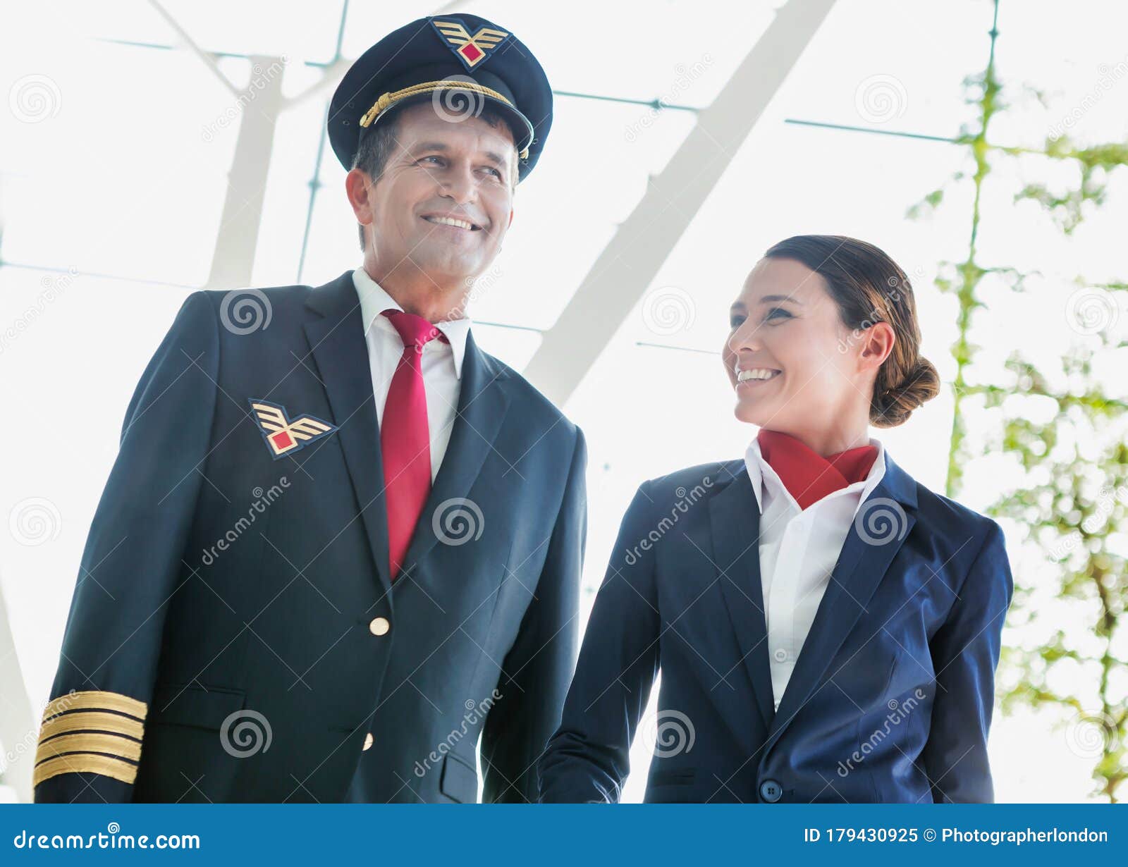Pilot With Flight Attendants Walking In The Airport Royalty-Free Stock ...