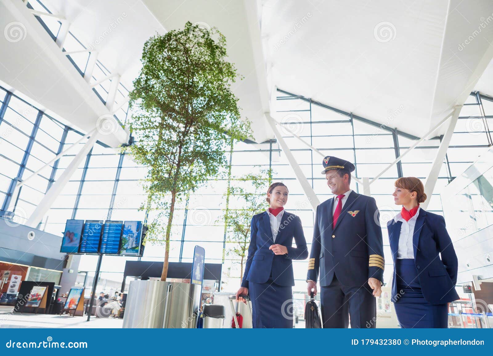 Pilot with Flight Attendants Walking in the Airport Stock Photo - Image ...