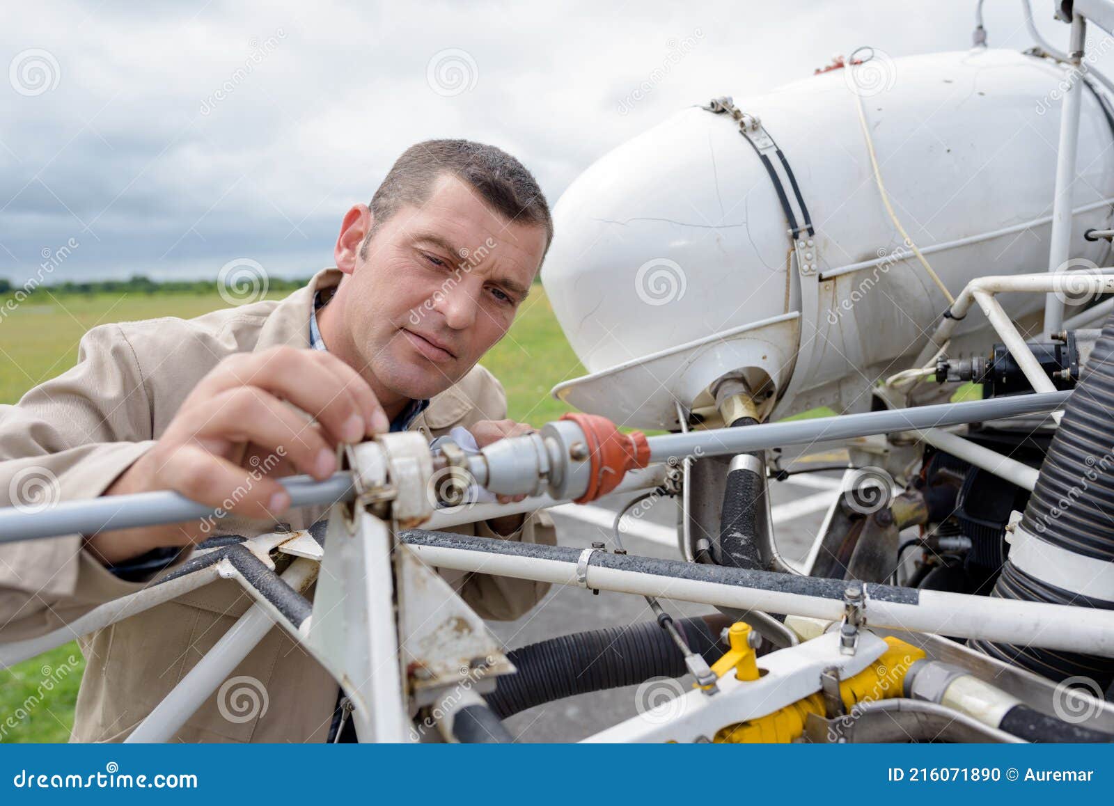 Pilot with Plane in Airport Stock Photo - Image of fixing, fixed: 216071890