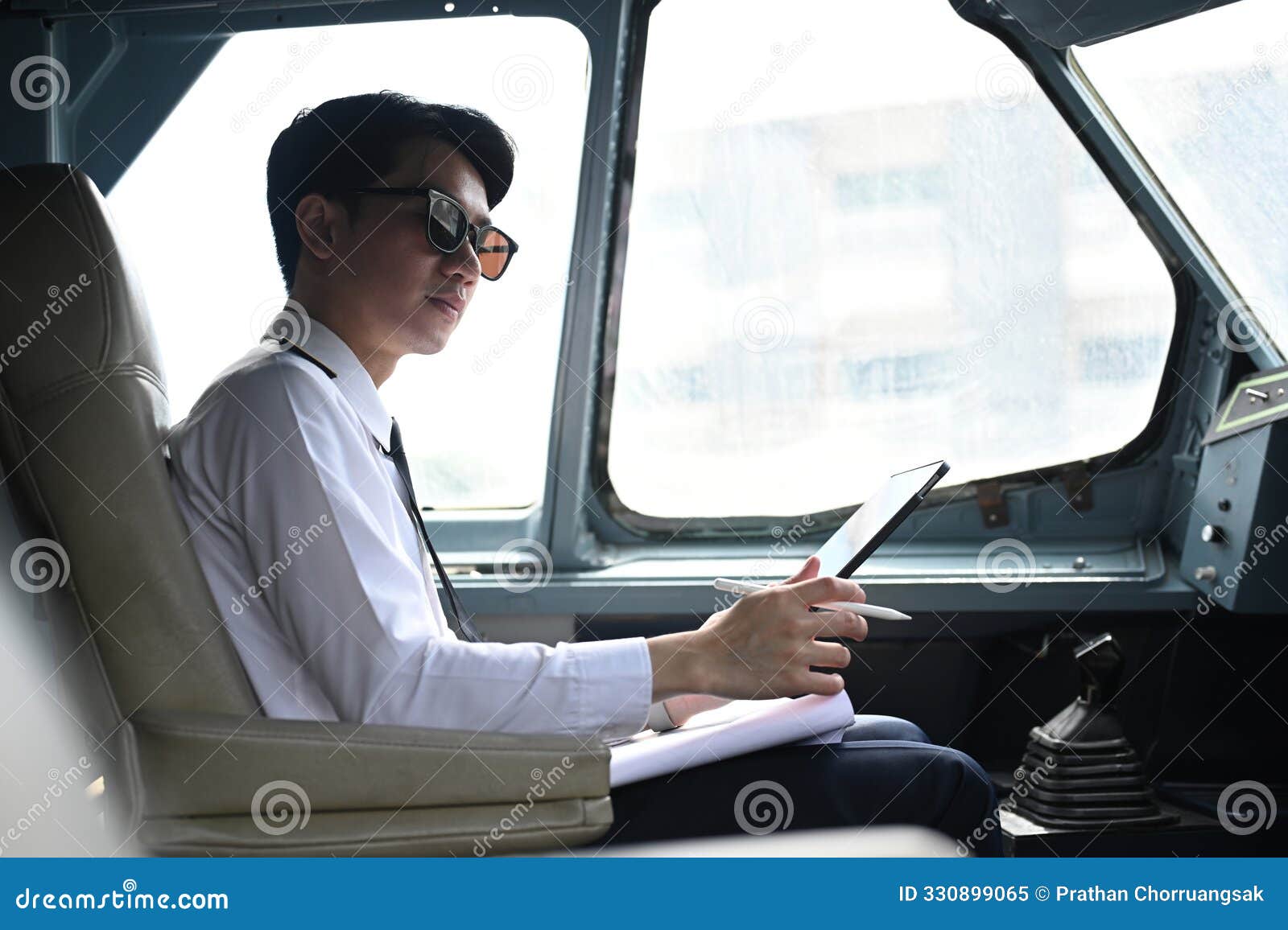 Pilot Preparing Flight Path and Check List from Digital Tablet in the ...