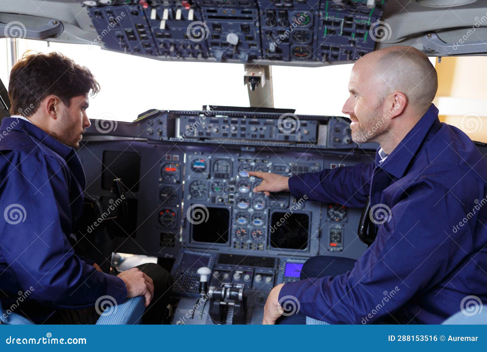 Pilot Talking with Apprentice in Cabin Stock Photo - Image of ...