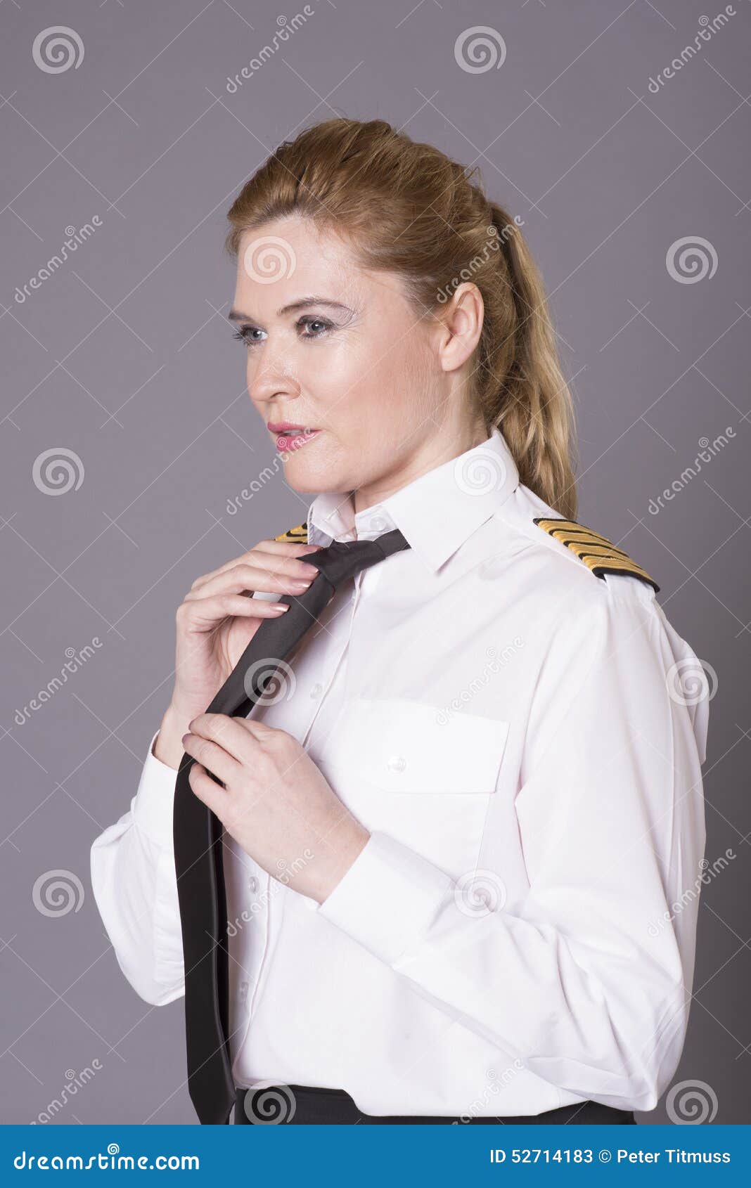 Pilot tying her tie stock image. Image of wearing, captain - 52714183
