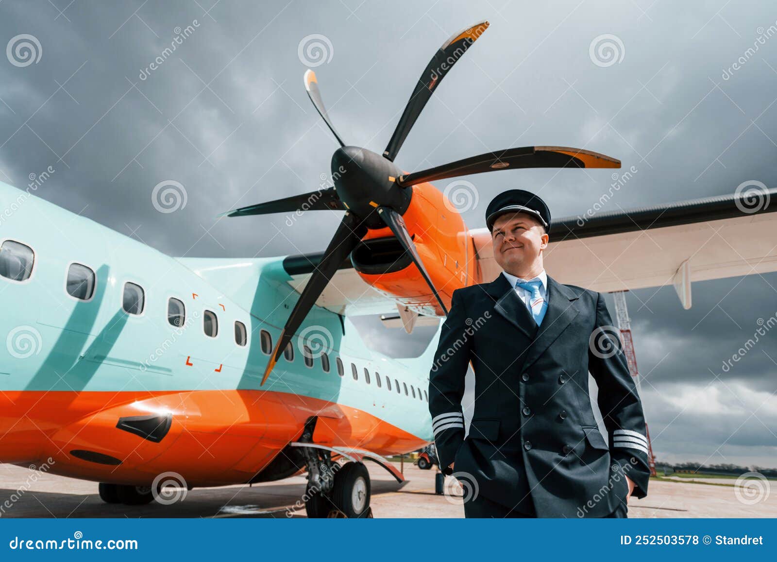 Pilot in Uniform Standing Outdoors Near Modern Airplane Stock Photo ...