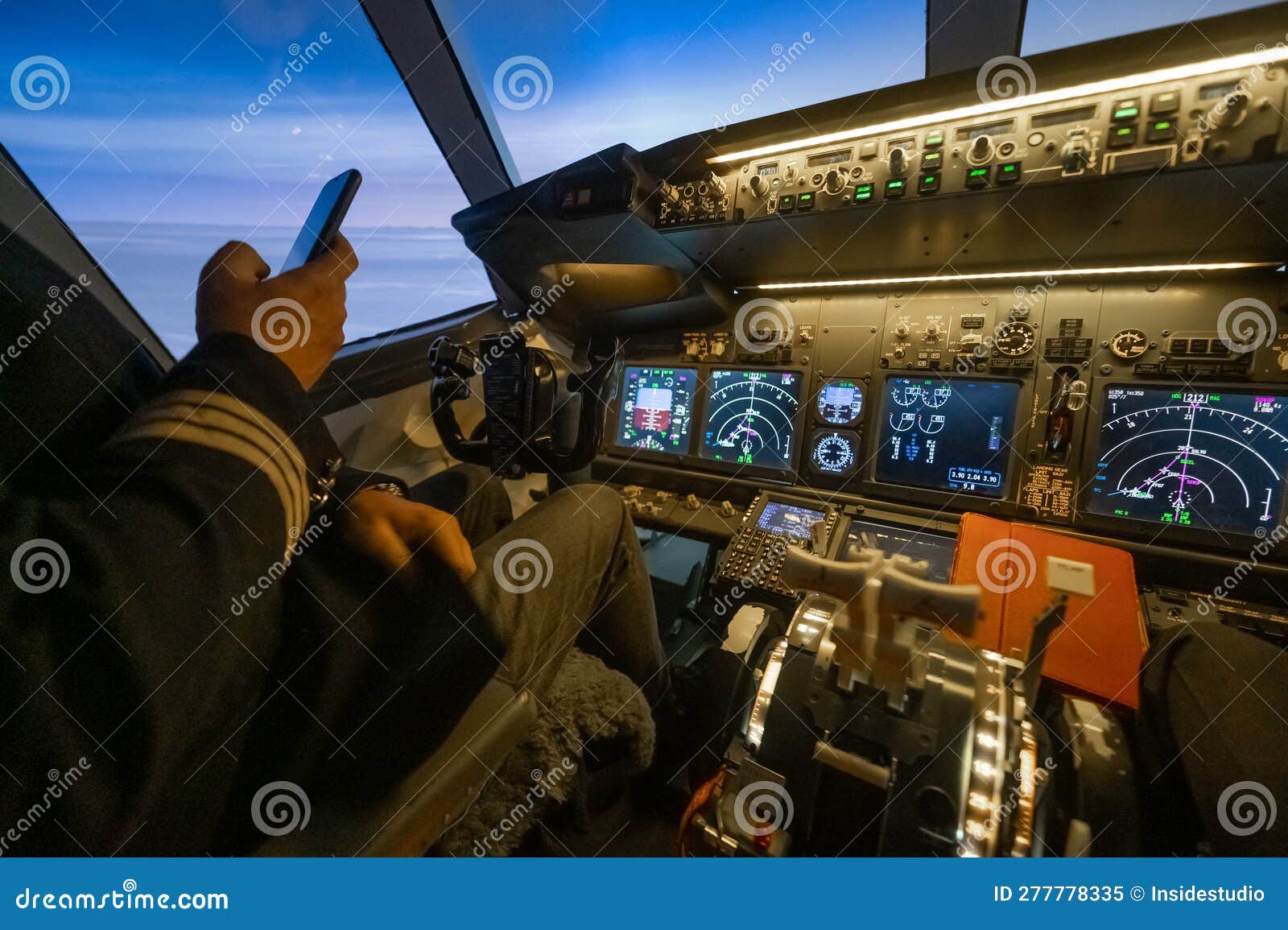 The Pilot Uses a Smartphone while Flying the Plane. Autopilot. Stock ...