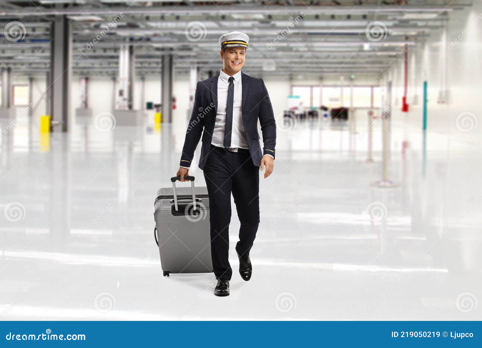 Pilot Walking and Pulling at an Airport Terminal Building Stock Image ...