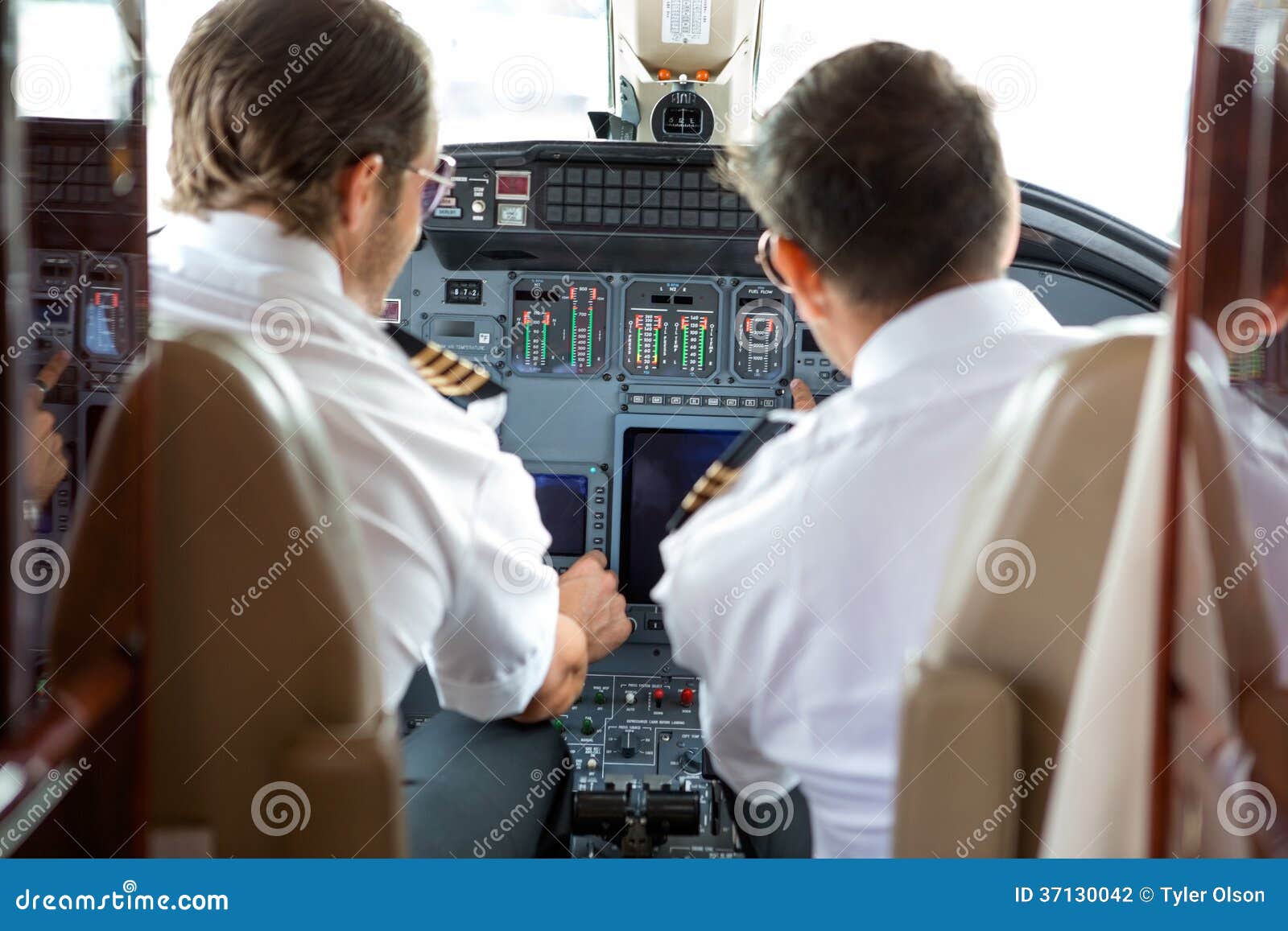 Pilots Operating Controls of Corporate Jet Stock Photo - Image of ...