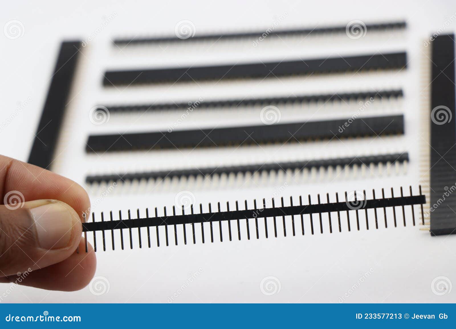 Pin Header Male Connector Held in Hand with Female Header Pins on the ...