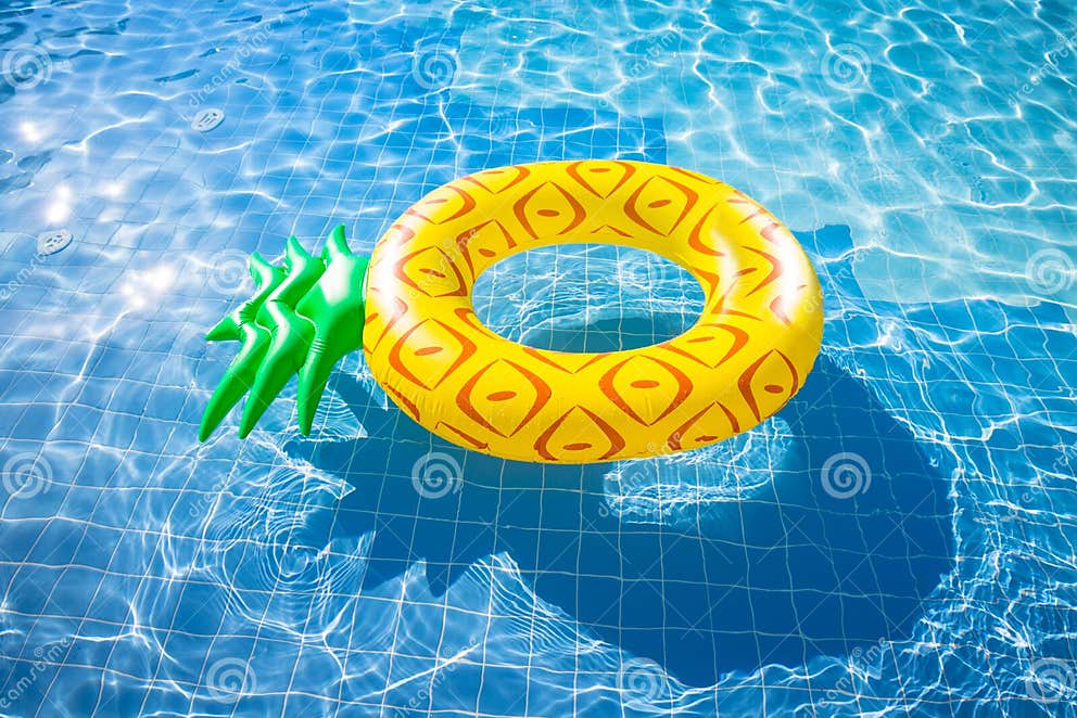 Pineapple Float Ring on the Blue Swimming Pool Stock Image - Image of ...