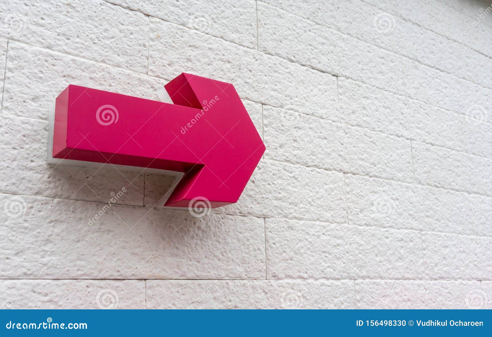 Pink Arrow Sign Hanging Against White Bricks Wall Stock Photo - Image ...