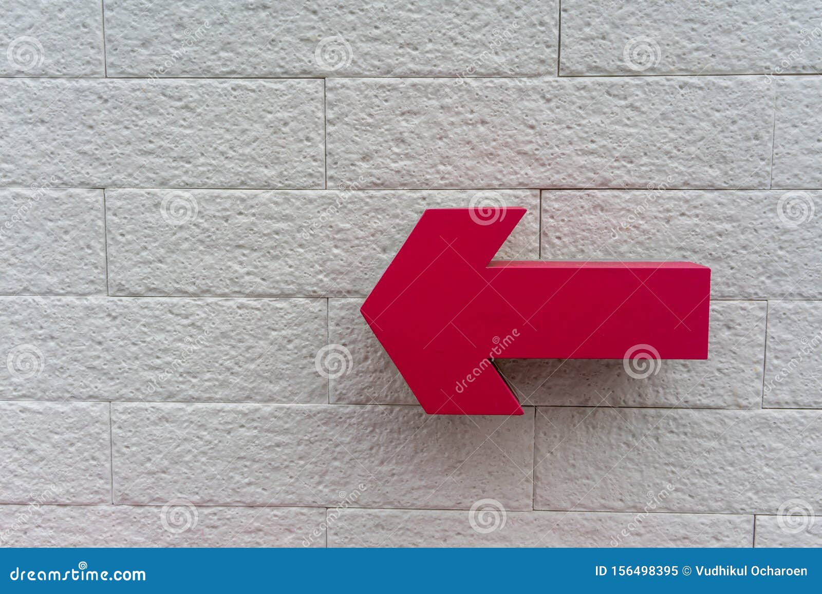 Pink Arrow Sign Hanging Against White Bricks Wall Royalty-Free Stock ...