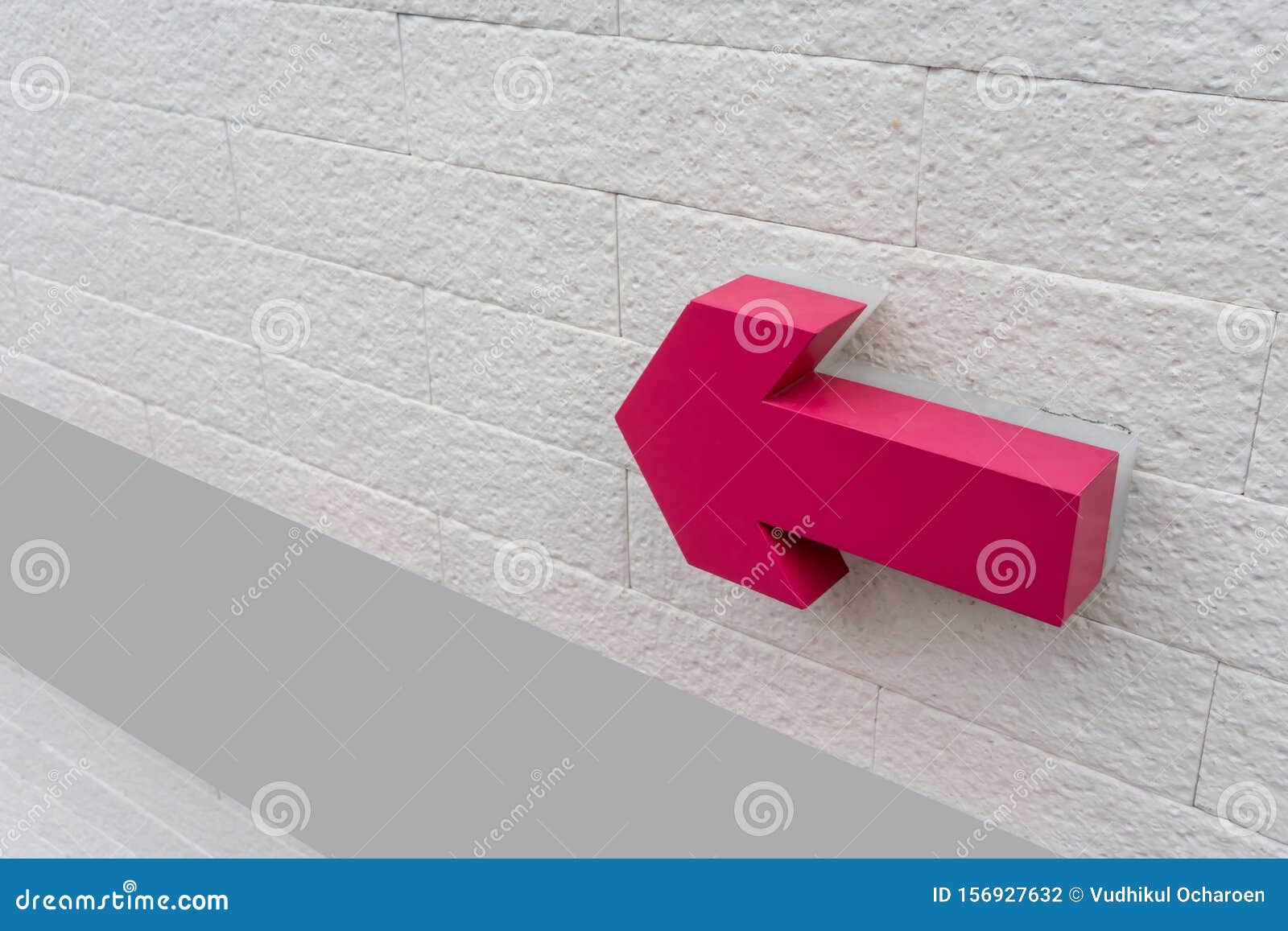 Pink Arrow Sign Hanging Against White Bricks Wall Stock Photo - Image ...