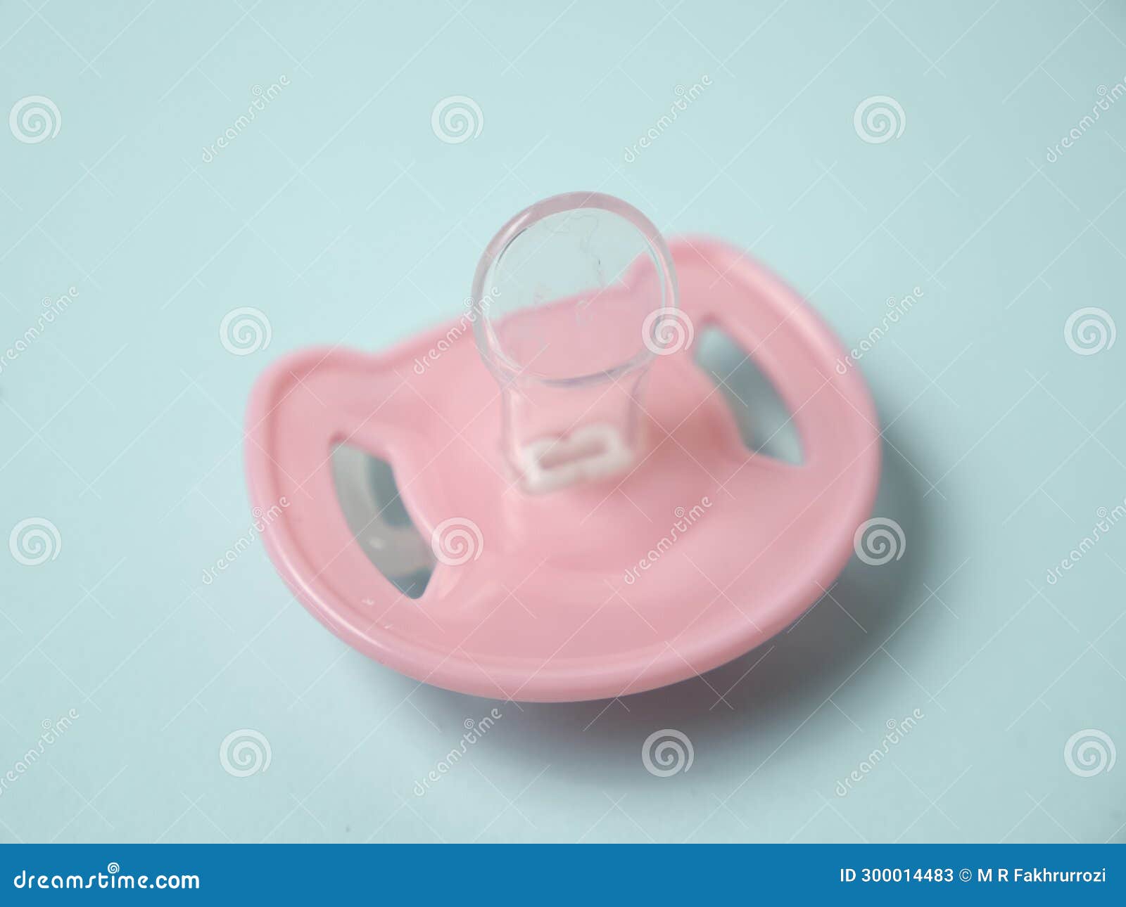 Pink baby pacifier on blue stock image. Image of infant - 300014483
