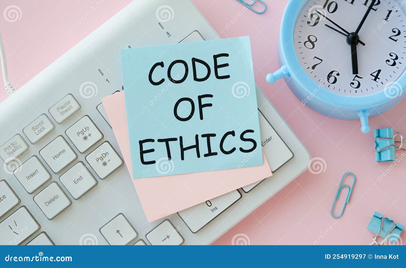On a Pink Background is a Notepad with the Words CODE of ETHICS, a ...