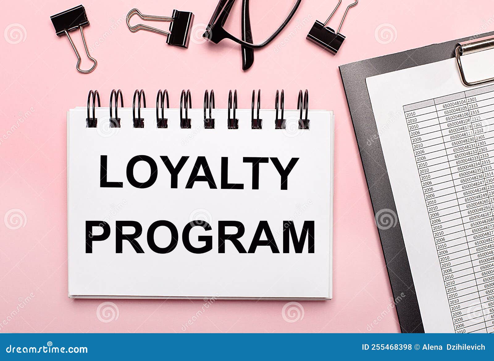 On a Pink Background, Reports, Black Paper Clips, Glasses and a White ...