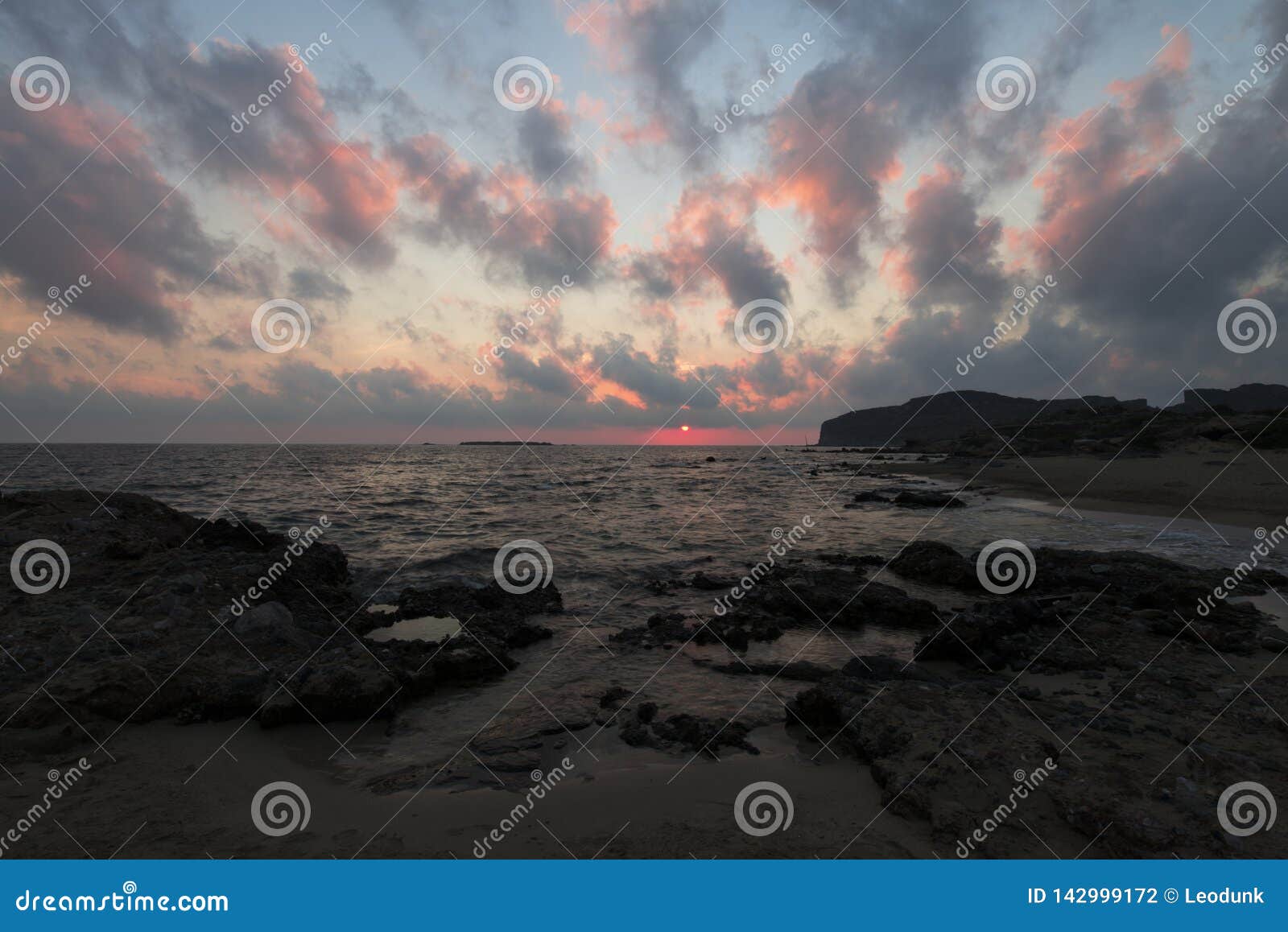 Pink Sunset on the Beach in Creta, Greece. Beach with Blacks Rocks and ...