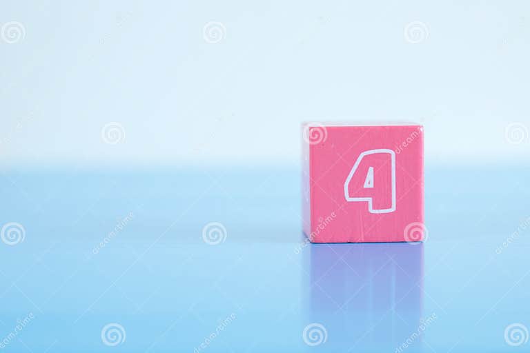 Pink Cube with the Number 4 on it Isolated on a Blue Gradient ...