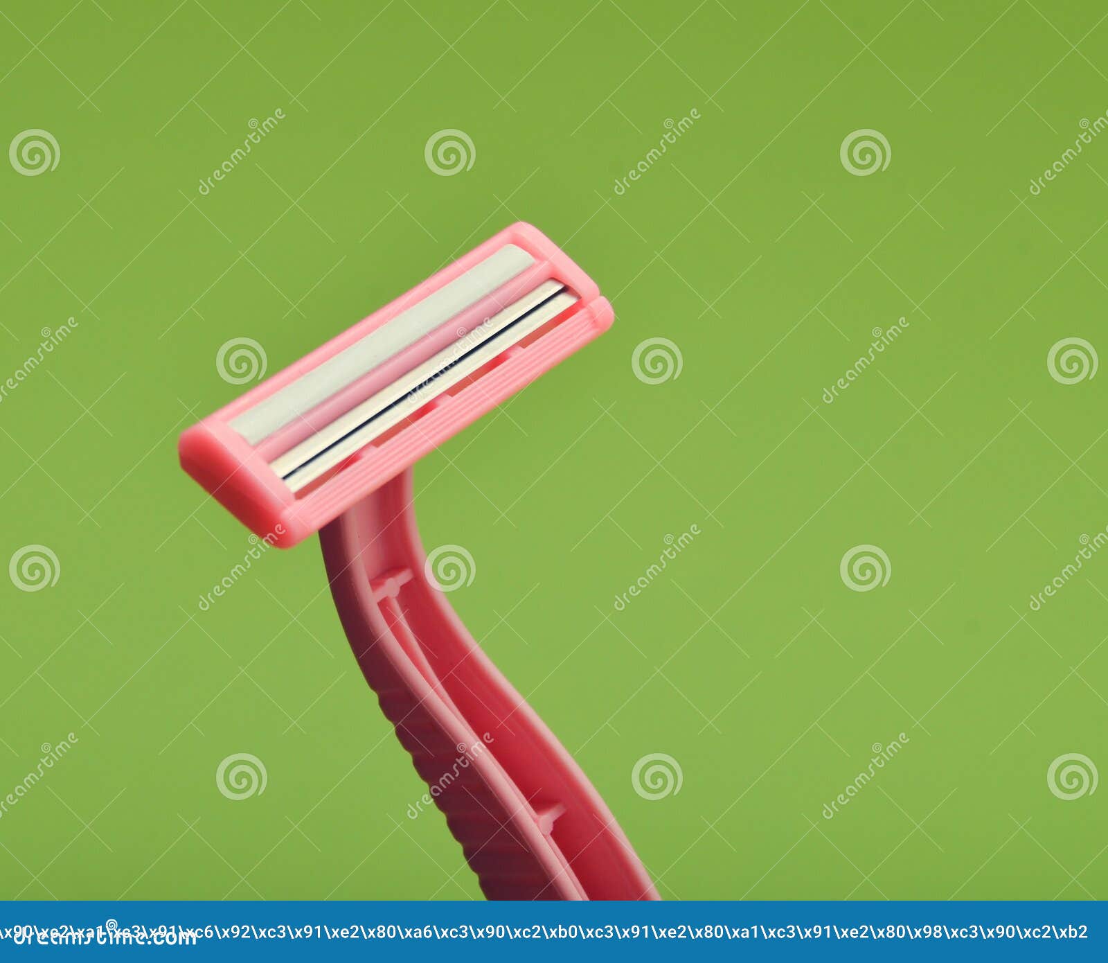 Pink Disposable Razor for Depilation on a Green Background Stock Image ...