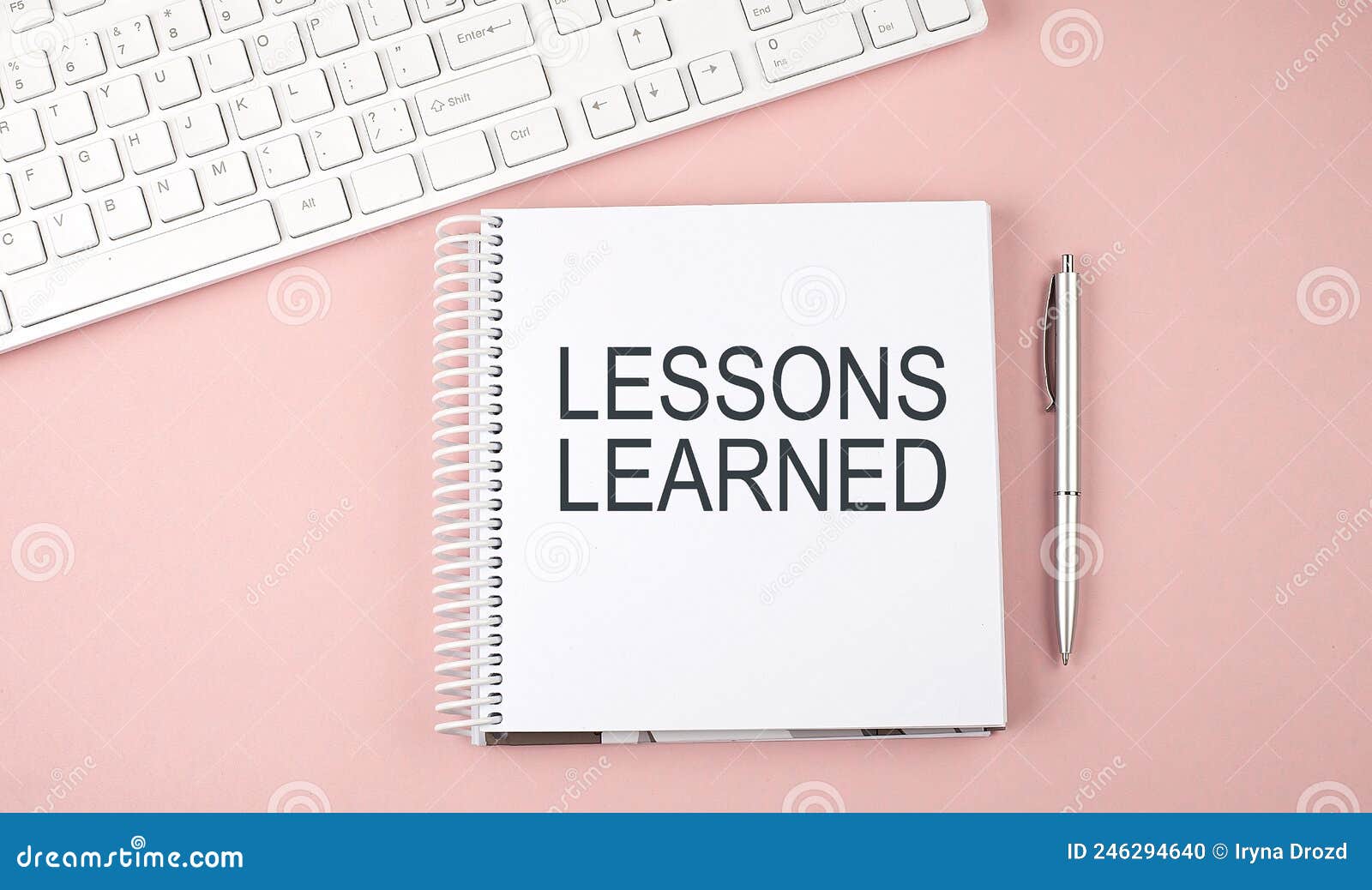 Pink Office Desk with Keyboard and Notebook with Text LESSONS LEARNED ...