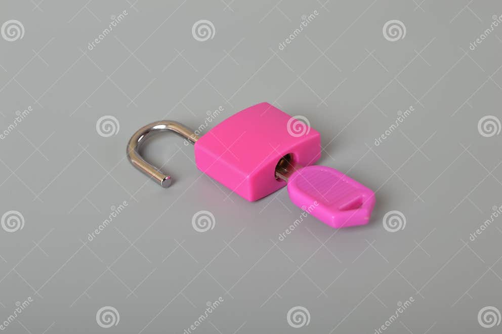 Pink Padlock and Key Isolated on a Grey Background. Copy Space for the ...