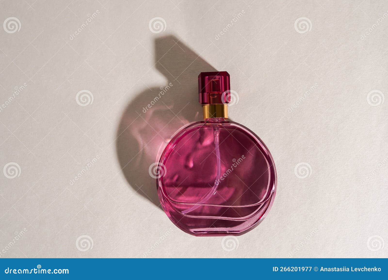 Pink Perfume Bottle with Reflections and Contrasting Shadows on Light ...