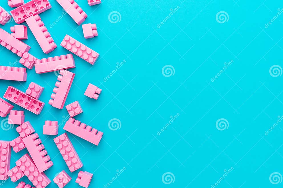 Pink Plastic Building Blocks on Turquoise Blue Background with Copy ...