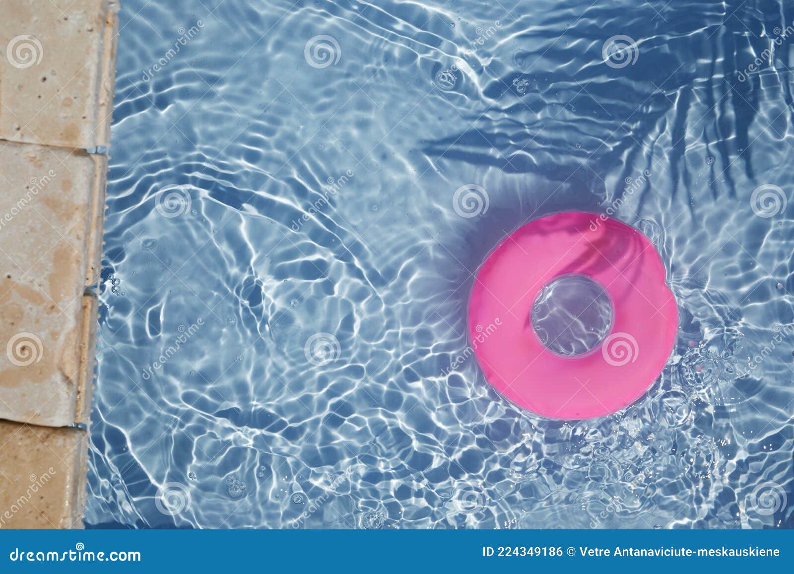 Pink Pool Float Ring Floating in a Refreshing Blue Swimming Pool. Top ...