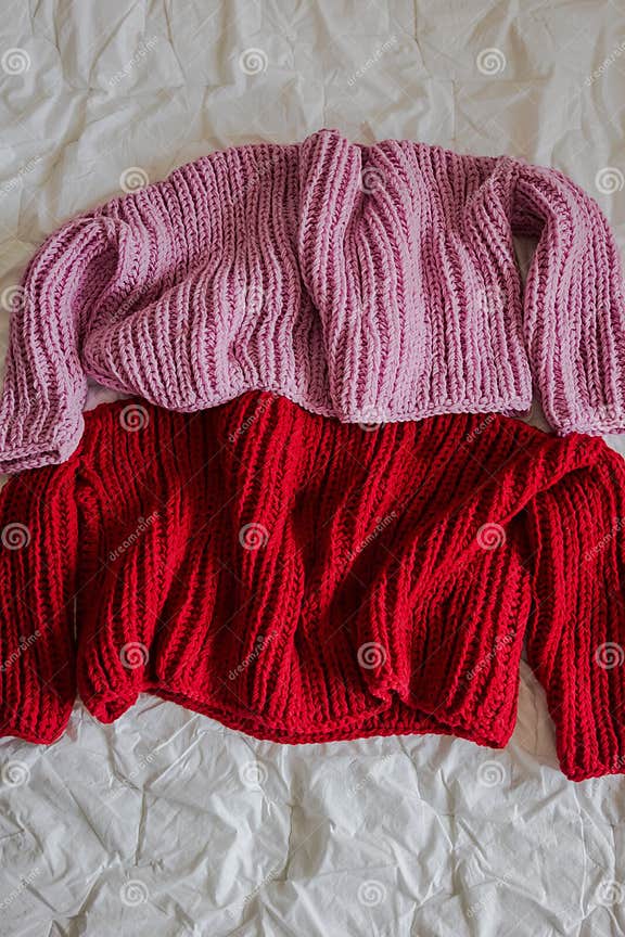 Pink and Red Sweaters on a Bed Stock Image - Image of winter, oversize ...