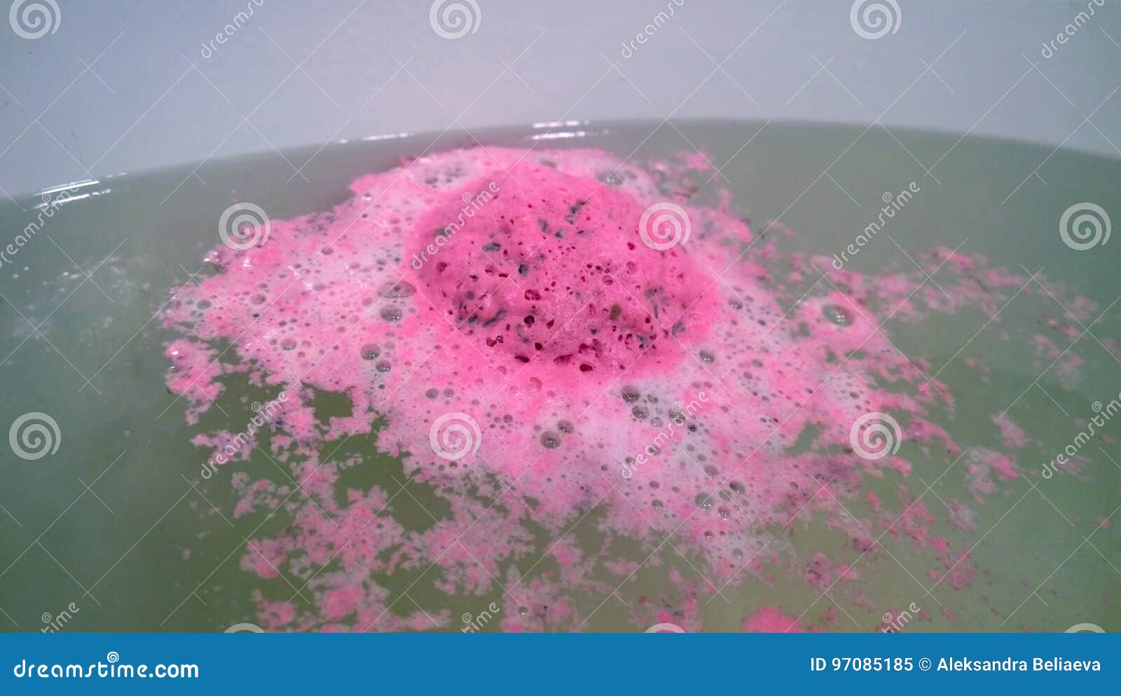 Pink Round Bath Bomb Dissolves in Water. in the Frame Edge of the White ...