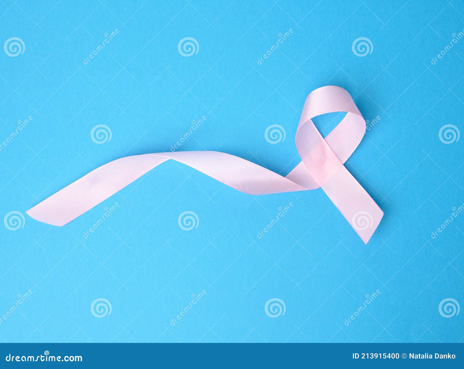 Pink Silk Ribbon in the Shape of a Loop on a Blue Background Stock ...