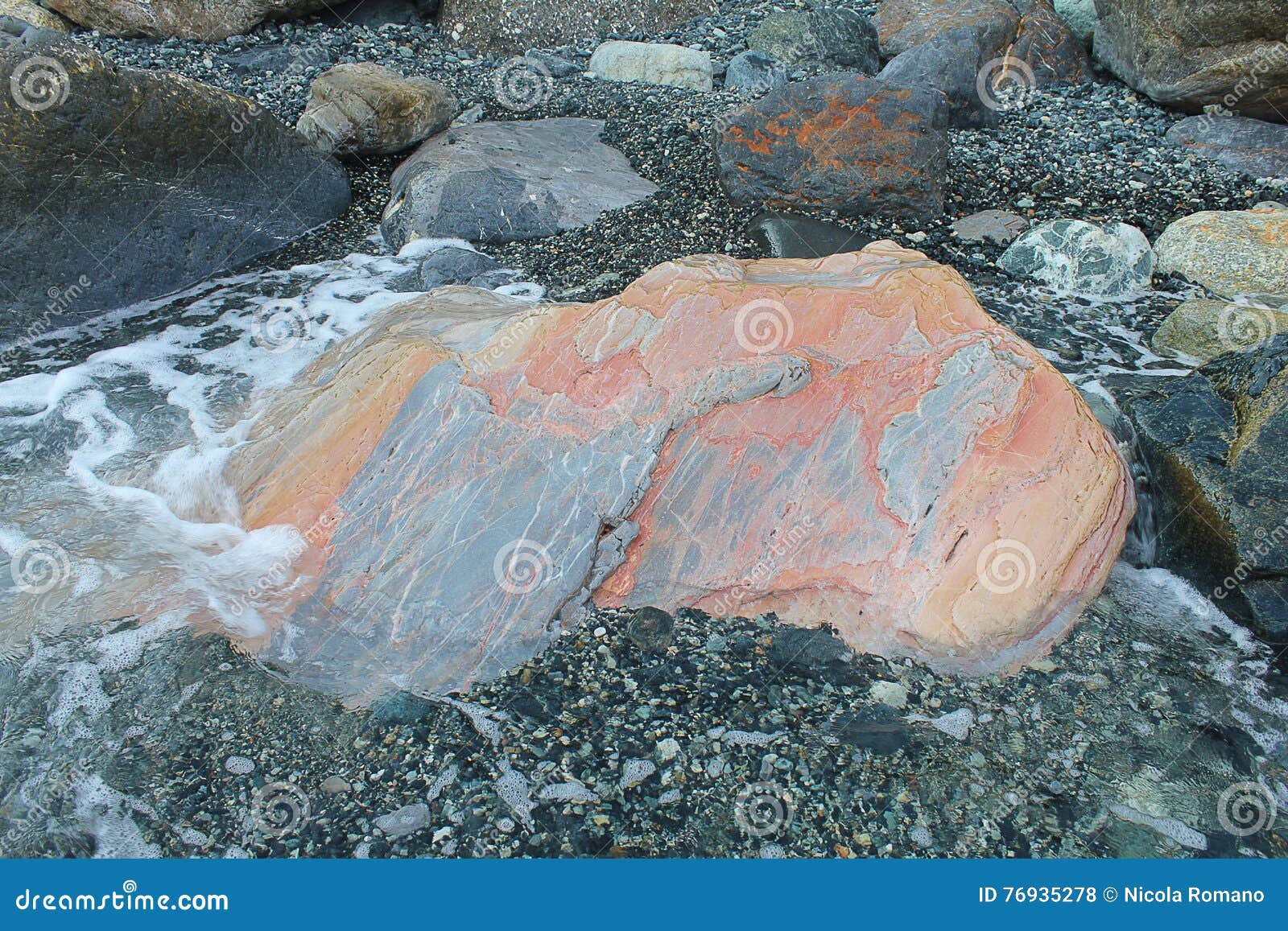 Pink stone on the beach stock photo. Image of mineral - 76935278