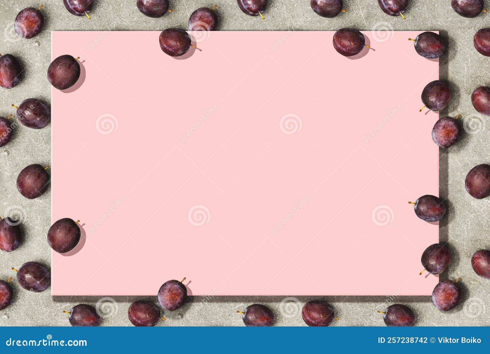 Pink Surface with Plums on a Gray Stone Around the Edge Stock Photo ...