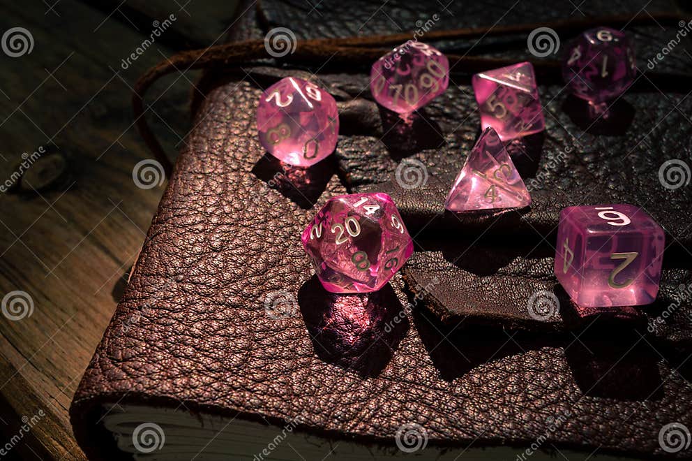 Pink Transparent RPG Dice on a Leather-bound Notebook Stock Photo ...
