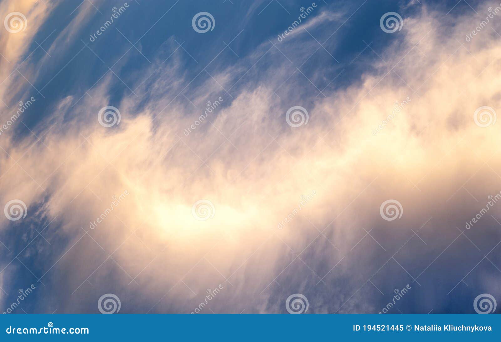 Pinkish Cloud Against a Blue Sky in the Rays of the Setting Sun. Stock ...