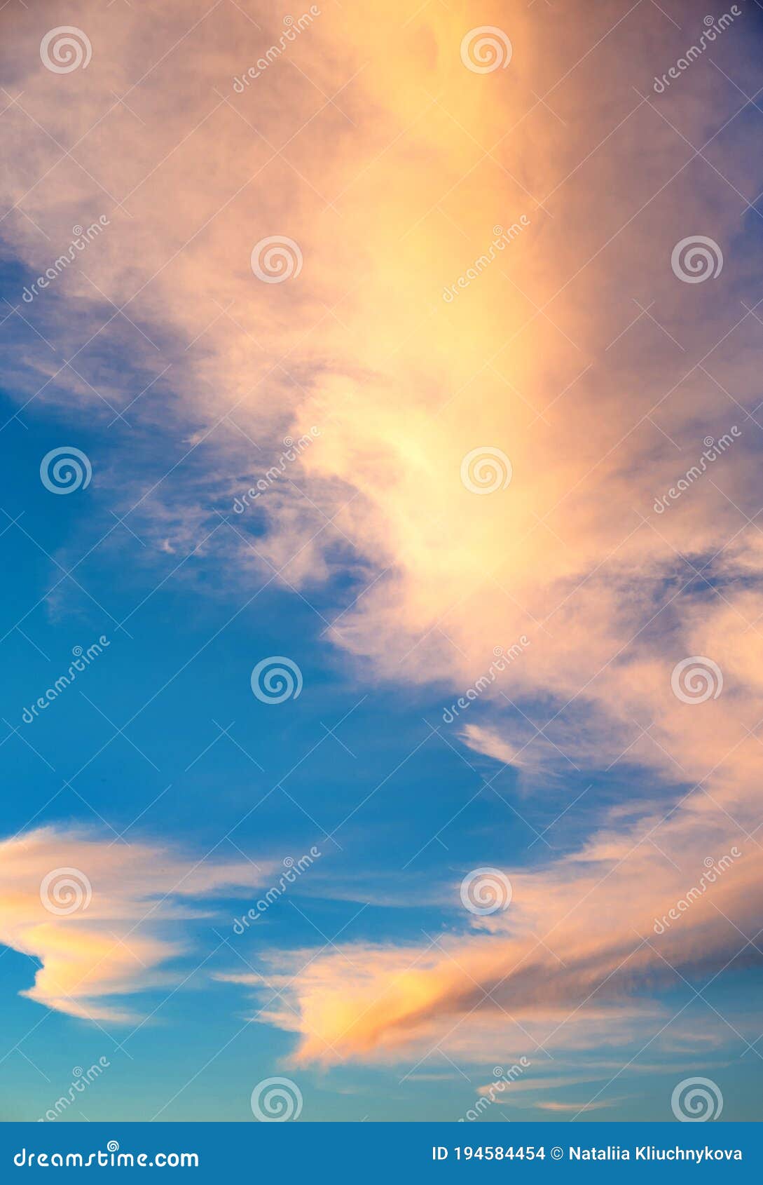 Pinkish Cloud Against a Blue Sky in the Rays of the Setting Sun. Stock ...