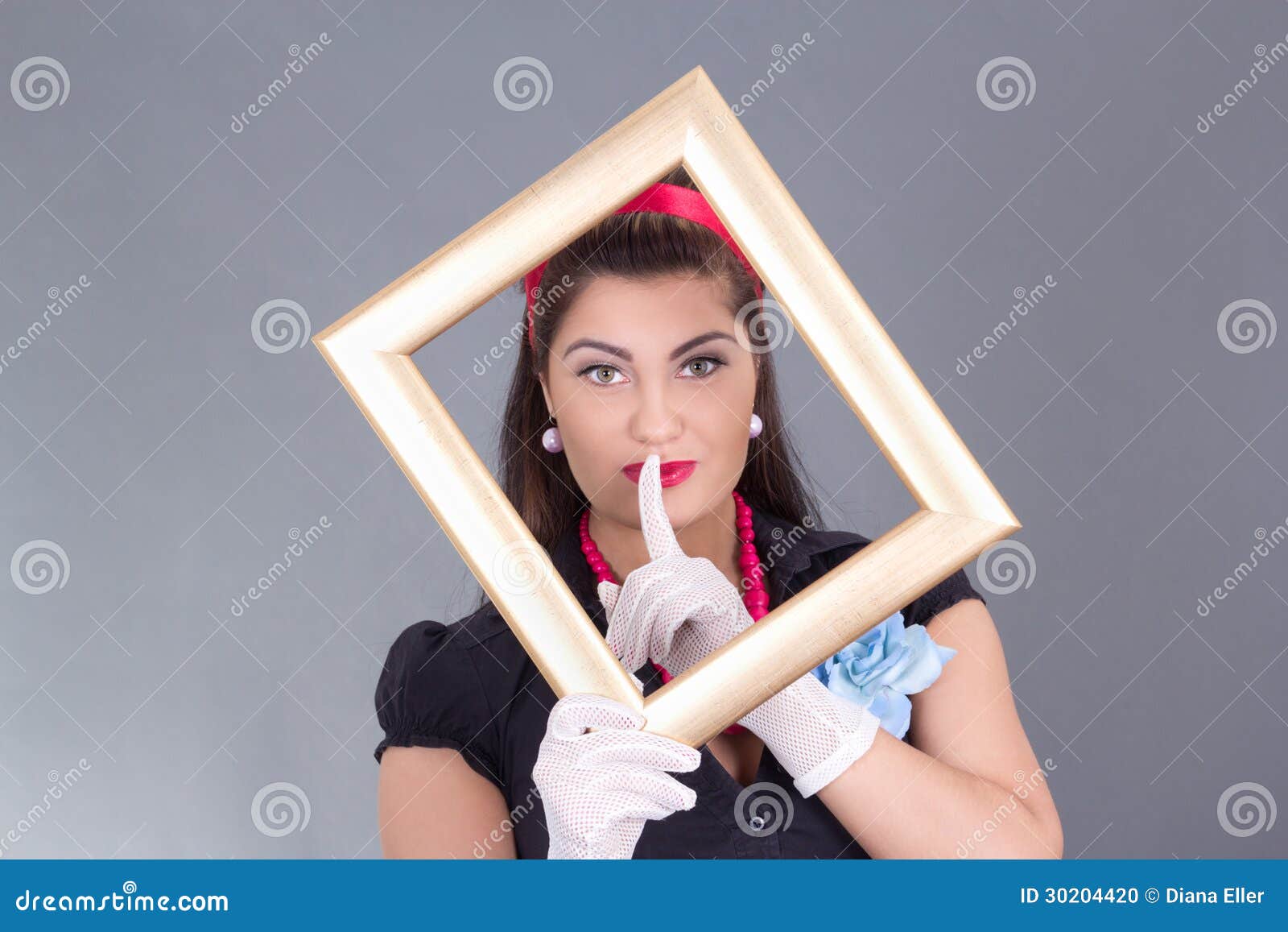 Pinup Girl with a Frame Around Her Face and Finger on Lips Stock Photo ...