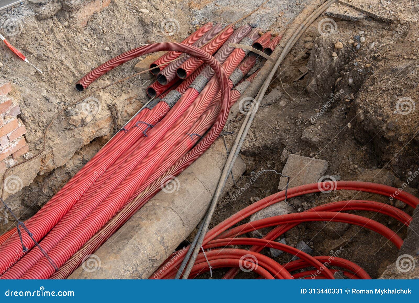 Pipe and Cables in Red Corrugated Pipe are Buried Underground on the ...