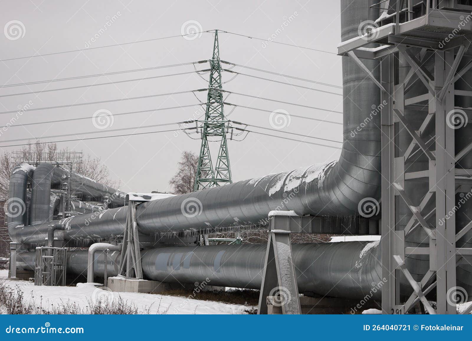 Pipeline and Power Line in the City in Winter Against the Gray Sky ...