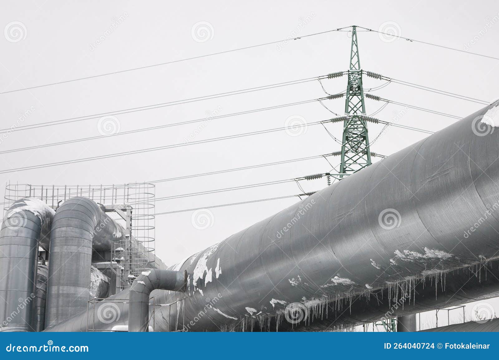 Pipeline and Power Line in the City in Winter Against the Gray Sky ...