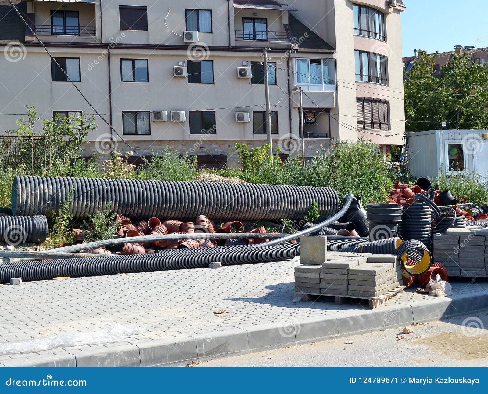 Pipes of Different Sizes and Pallets with Paving Slabs at the Site of ...
