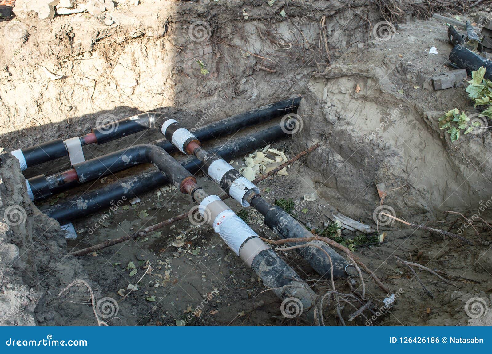 Pipes in the Earthen Trench for Heating System Stock Photo - Image of ...