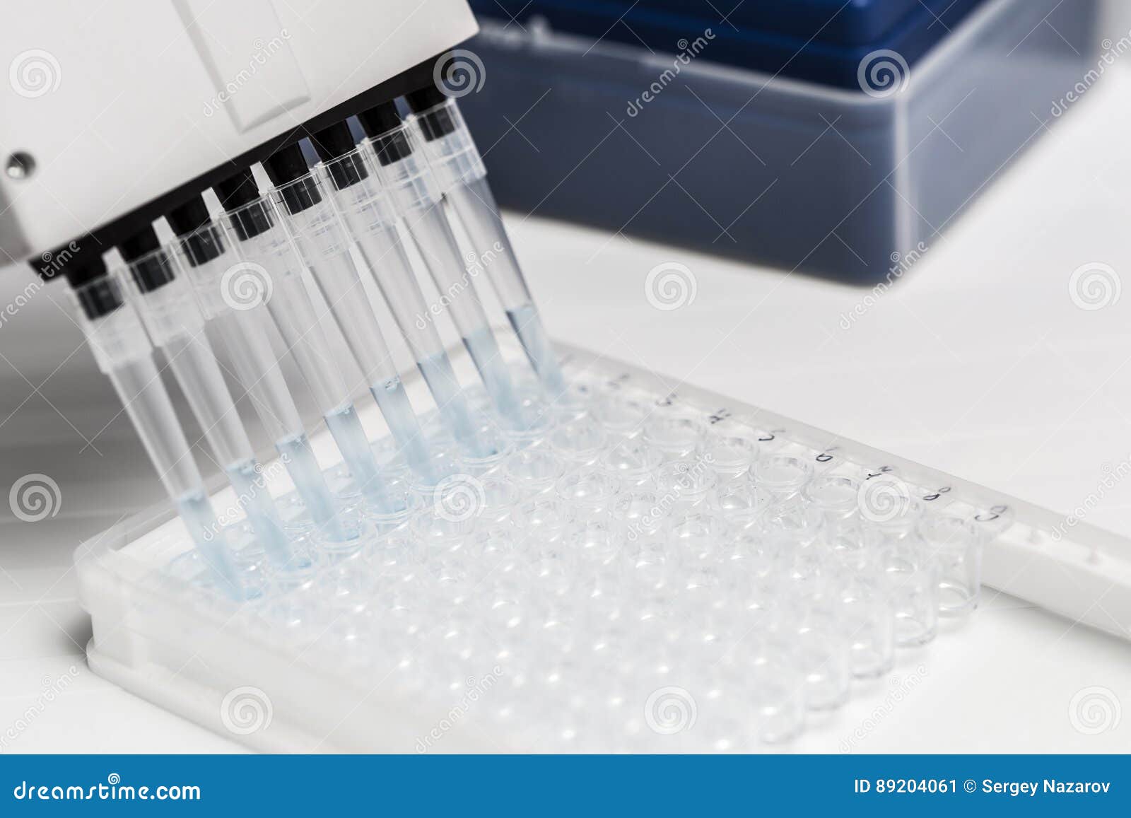 Pipette Depositing Samples into a 96 Well Micro-plate Stock Image ...