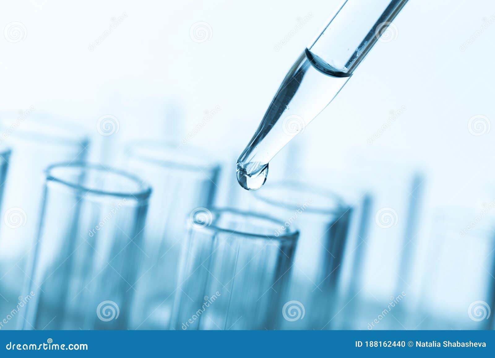 Pipette with a Drop and Scientific Laboratory Test Tubes in a Research ...