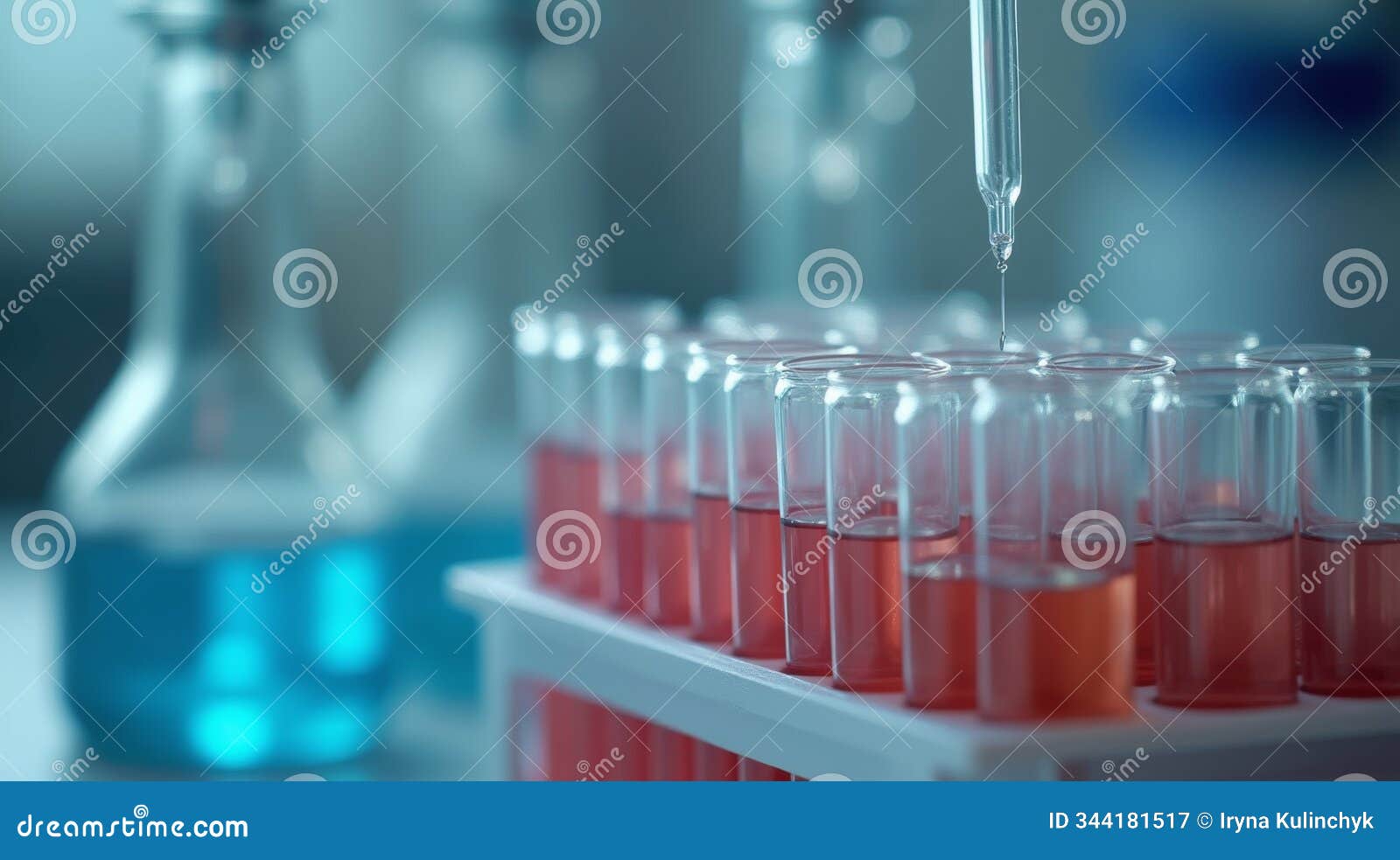Pipette Dropping Liquid into Test Tubes with Red Solution. Laboratory ...