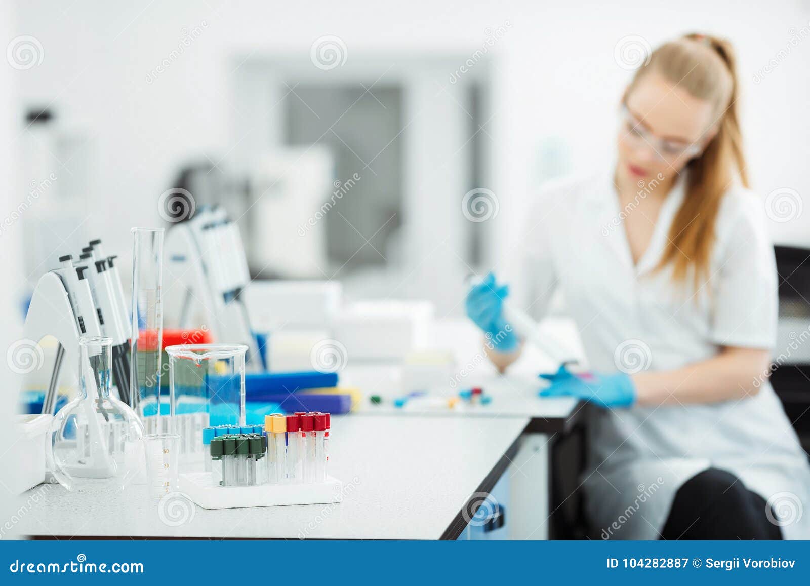 Pipette Dropping a Sample in a Test Tube. Laboratory Assistant ...