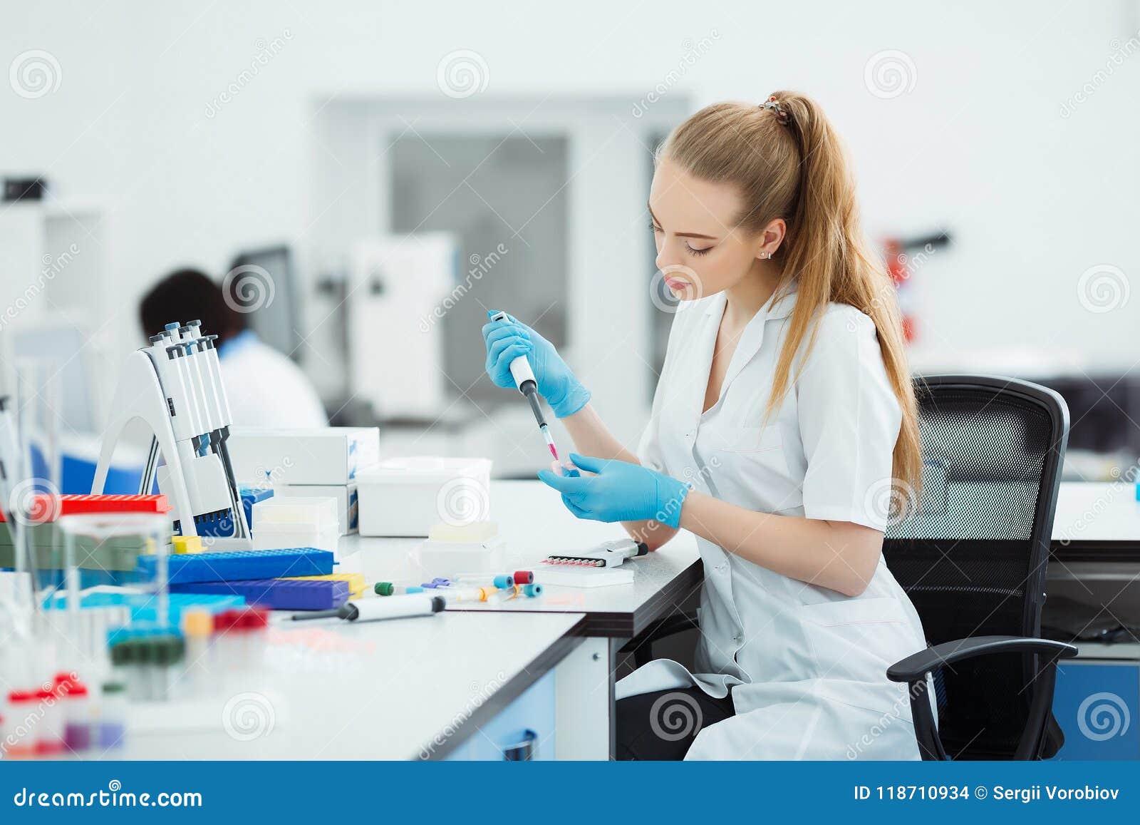 Pipette Dropping A Sample In A Test Tube. Laboratory Assistant ...