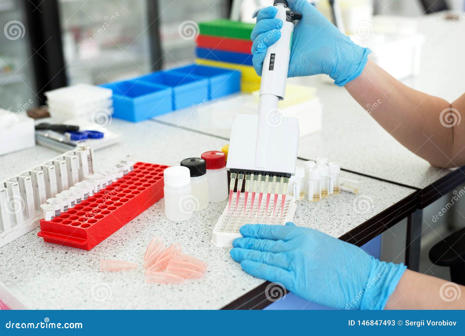 Pipette Dropping a Sample in a Test Tube. Laboratory Assistant ...