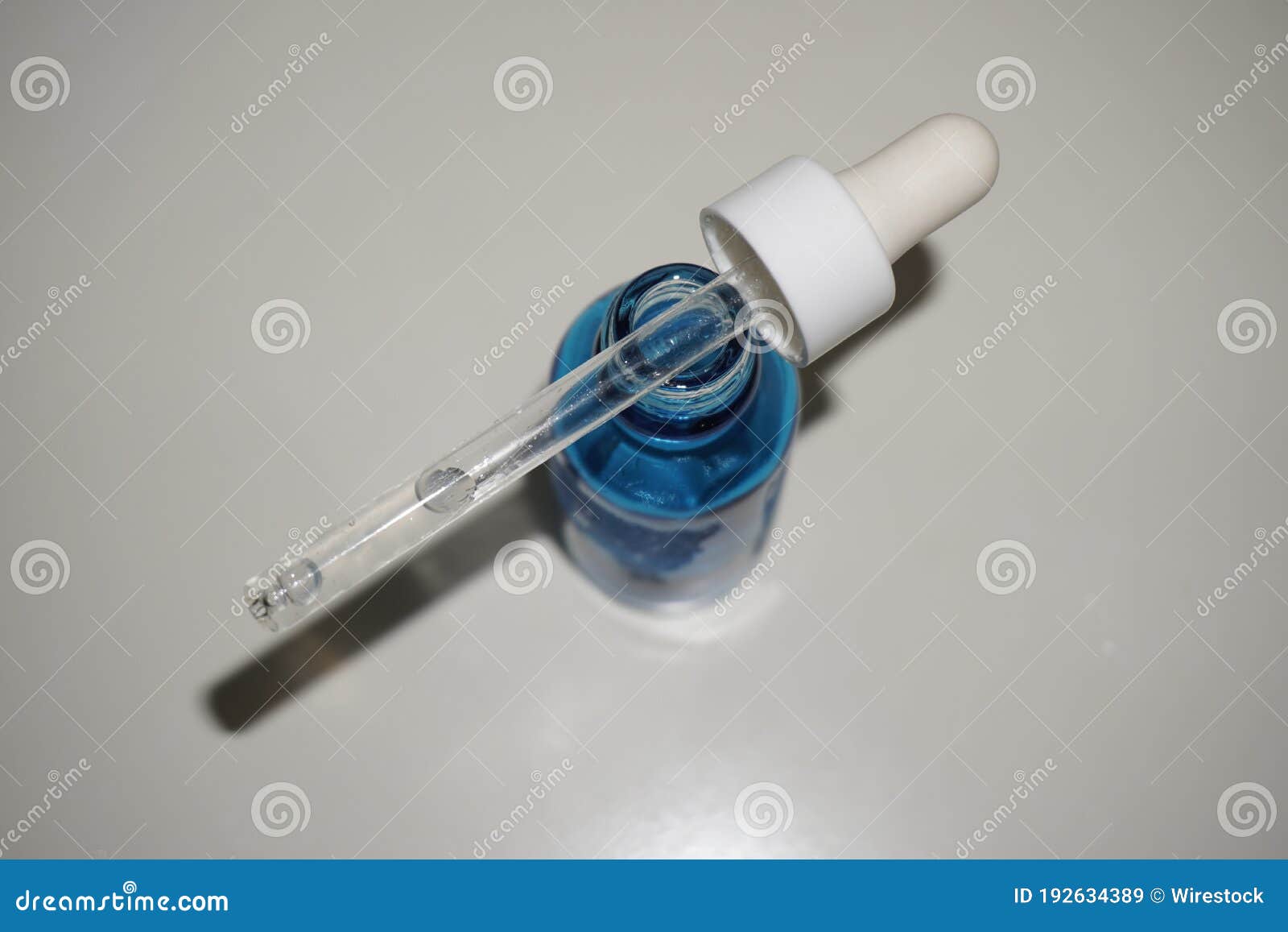 Pipette Placed on Top of a Container Filled with Blue Liquid Stock ...