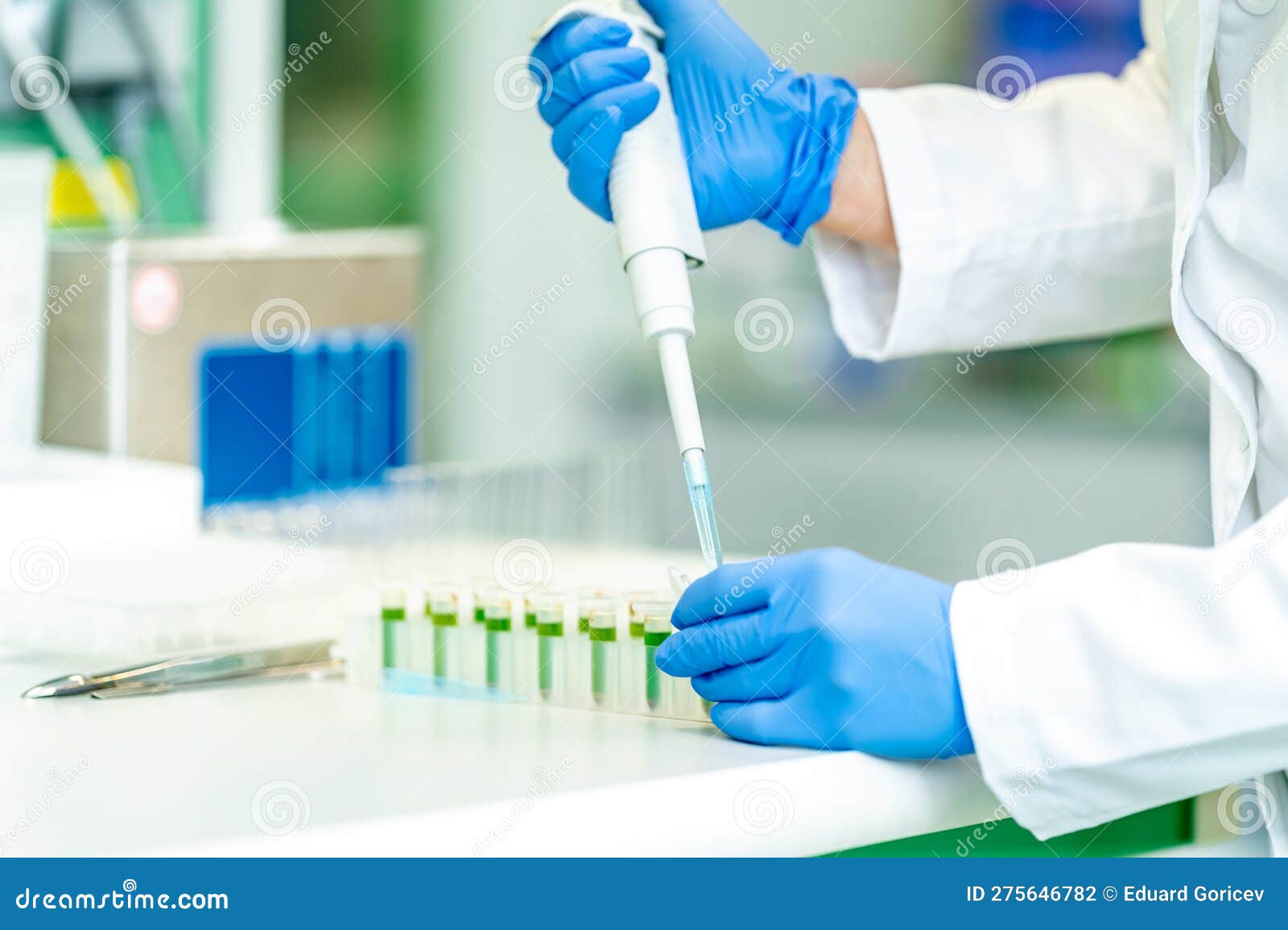 Pipetting a Sample into a Glass Beaker during Research in a Scientific ...