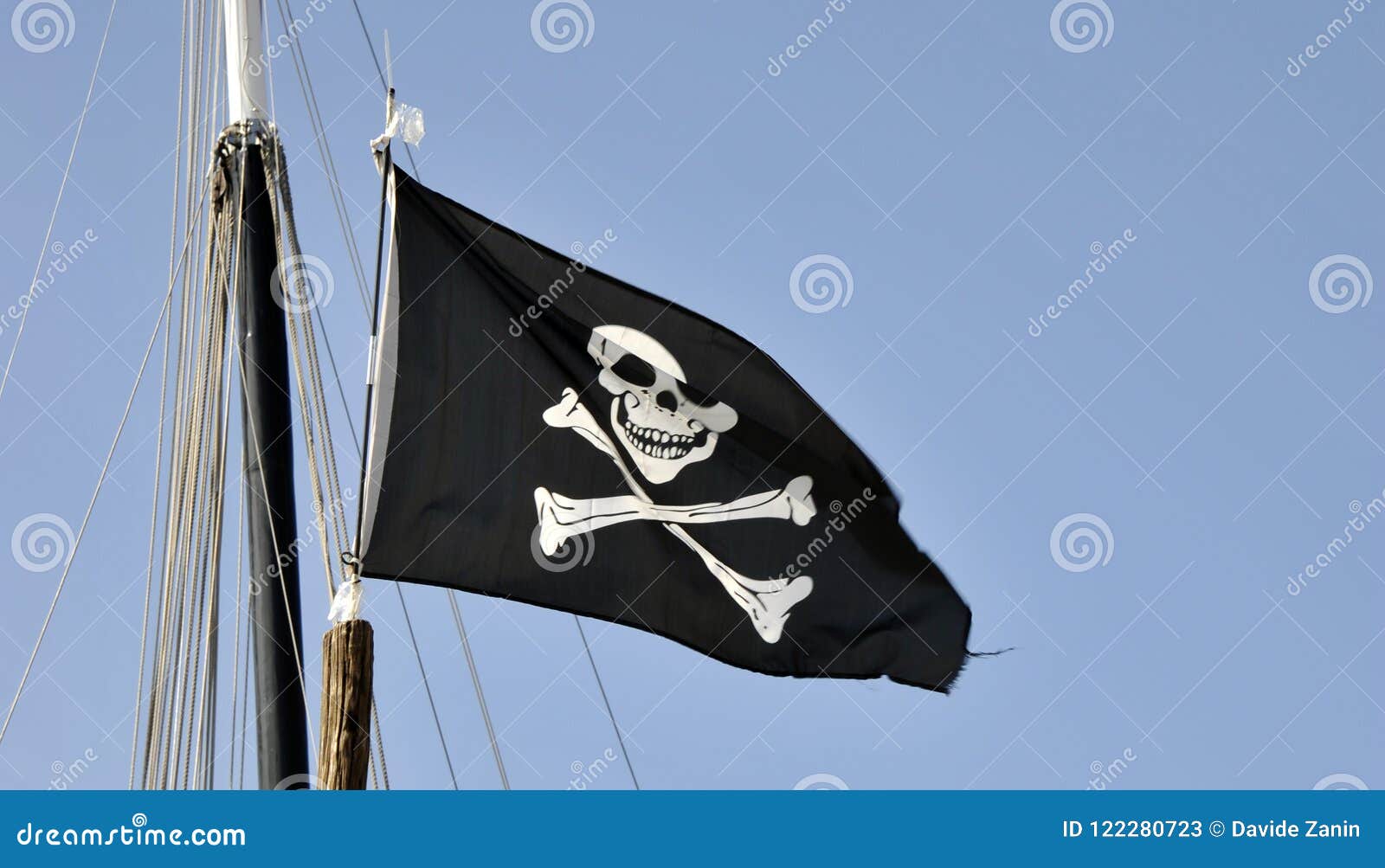 The Pirates Flag Waving on a Blue Sky Background Stock Image - Image of ...
