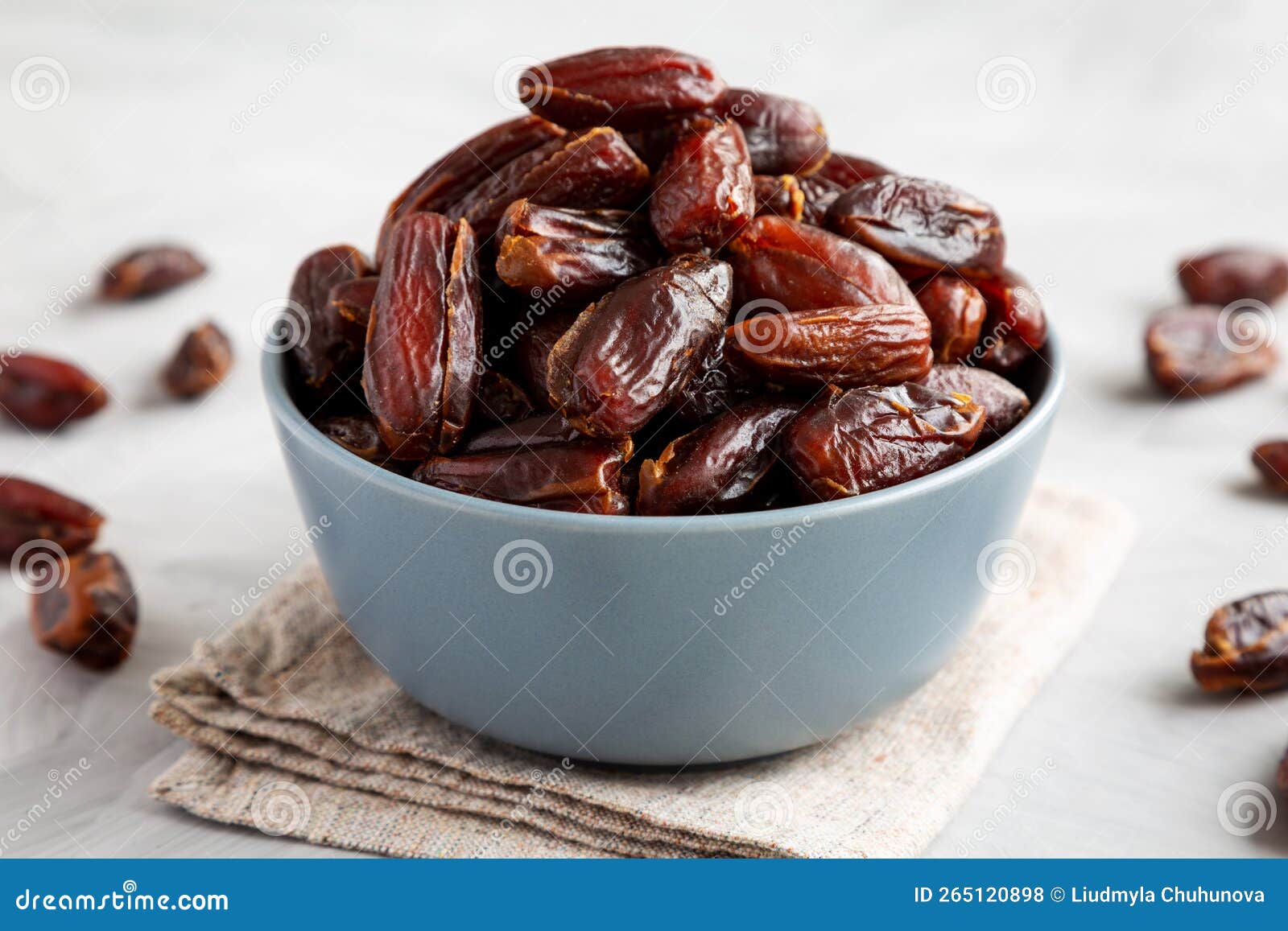 Pitted Organic Dates in Bowl on Gray Background, Side View Stock Photo ...